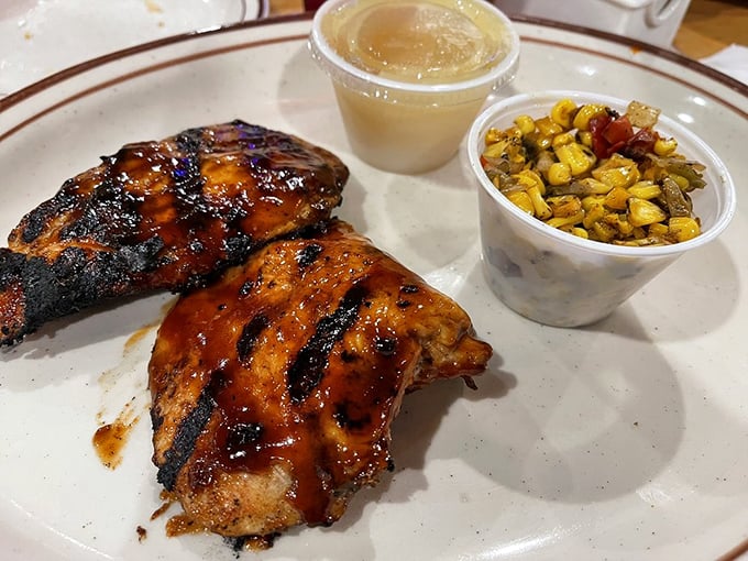 BBQ chicken that wears its grill marks like badges of honor. The corn medley alongside isn't an afterthought—it's essential for cutting through all that smoky richness.