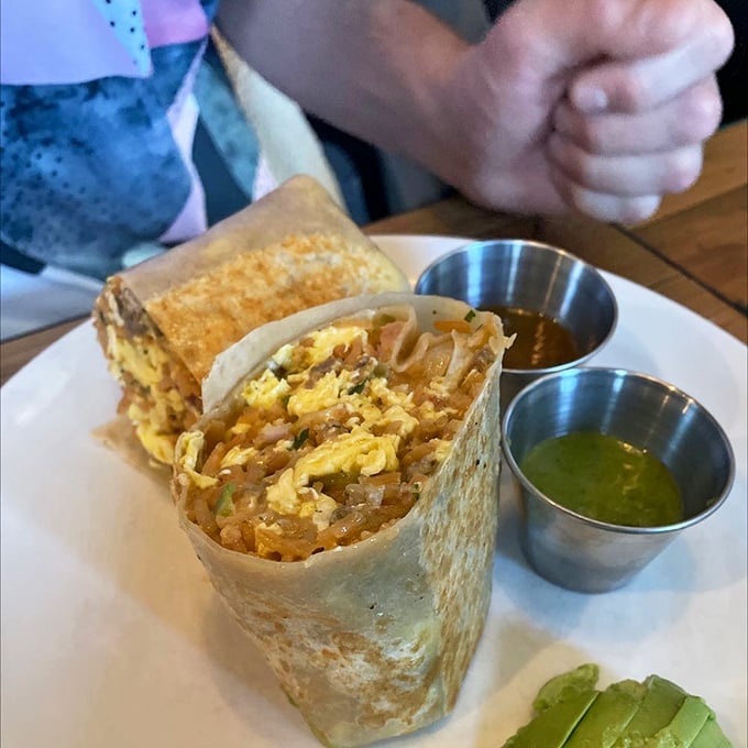 The breakfast burrito—where eggs, cheese and Mexican rice find their higher purpose, flanked by salsa verde that kicks your taste buds awake.