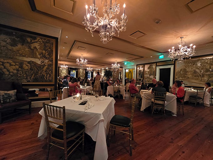 Dinner guests bask in chandelier light against historic walls—the kind of ambiance you can't manufacture with an Instagram filter.