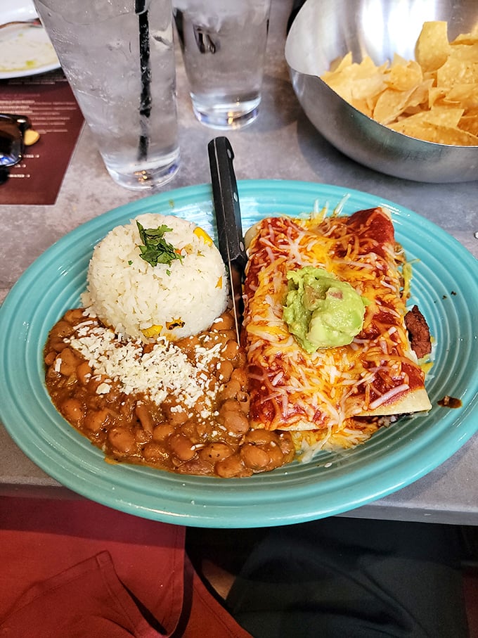 Not all heroes wear capes—some wear melted cheese and sit beside perfectly cooked rice and beans on turquoise plates.