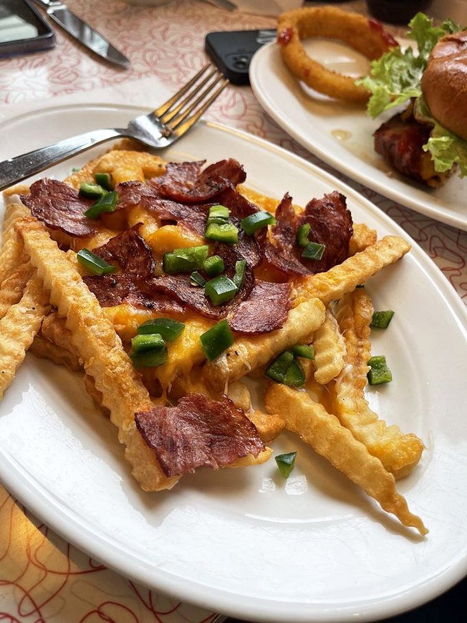 Loaded fries that don't just cross the line into decadence—they sprint past it. Bacon, cheese, and green onions transform mere potatoes into a celebration.