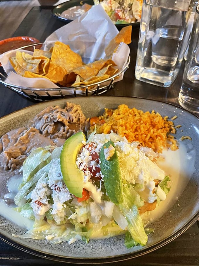 This plate has it all – a perfectly rolled chimichanga alongside rice the color of a Carolina sunset and beans that didn't come from any can.