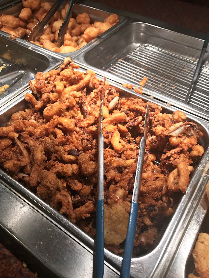 Fried calamari rings—the edible jewelry of the seafood world—perfectly golden and waiting to be claimed by the next passing plate. 