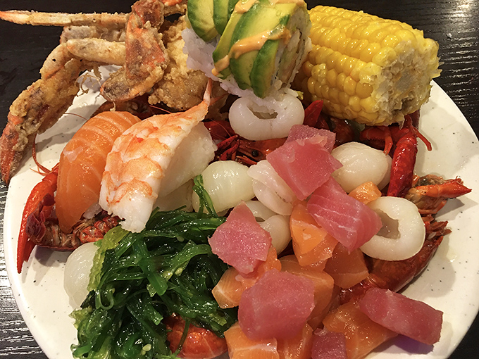 The ultimate seafood sampler plate – crab, corn, sashimi, and more sharing space in delicious harmony. This isn't a meal; it's an expedition across culinary continents.