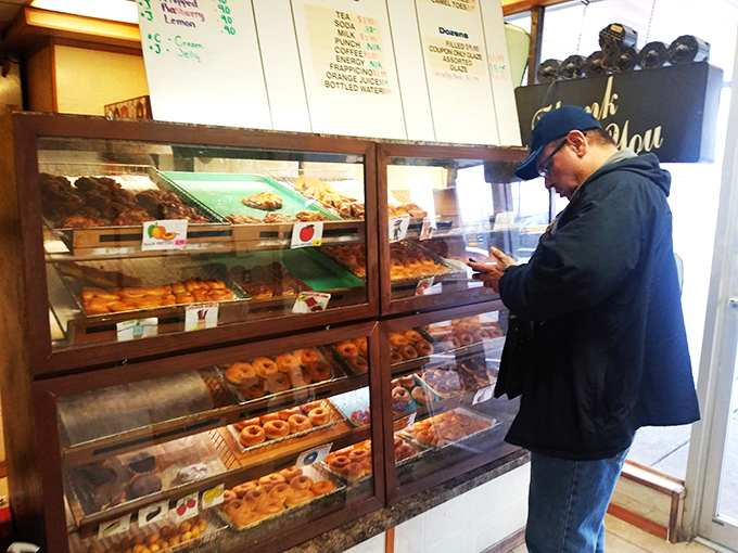 The moment of decision – a customer contemplates life's most important question: which donut deserves to come home today?