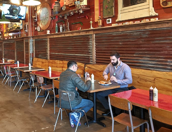 Two diners experiencing what philosophers call "chicken nirvana"—that moment when conversation pauses because the food demands full attention.