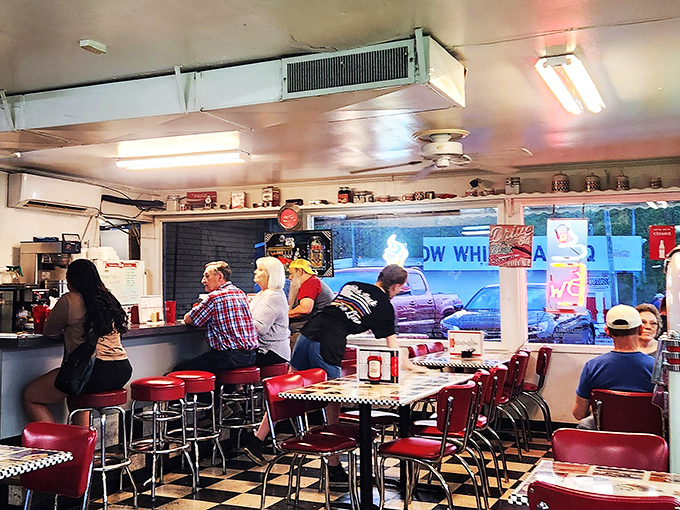 Morning regulars perched at the counter—the unofficial town council where coffee flows and local wisdom is dispensed freely.