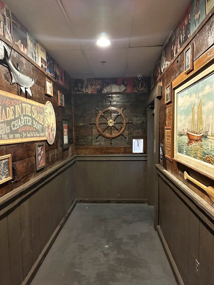 Nautical décor lines the hallway like a portal to coastal living—ship wheels and weathered signs transporting you far from the desert.