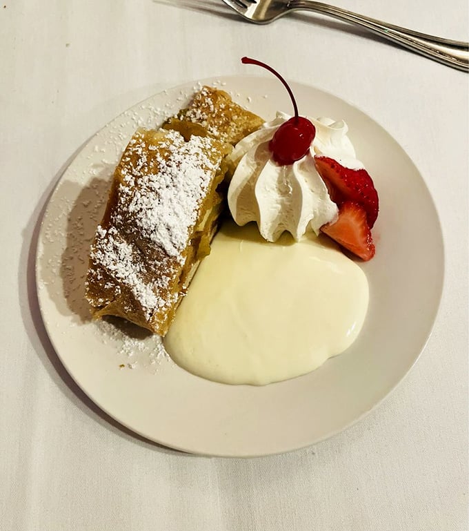 Apple strudel that crackles with each bite, served with a cloud of cream that makes you believe in dessert divinity.