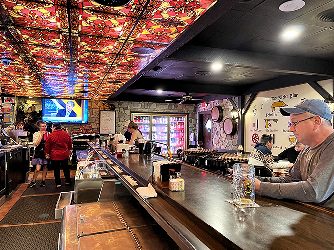 The bar's colorful ceiling isn't just eye-catching—it's a conversation starter. Many great friendships have begun under those lights with a "Prost!" and a clink.