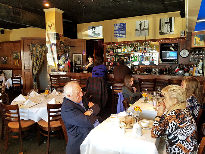 The bar area offers a front-row seat to the restaurant's warm hospitality, where regulars and first-timers alike are welcomed into the Café Provence family.