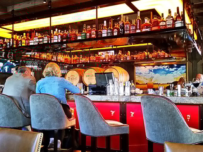 The bar glows like a treasure chest of spirits, with bottles backlit to showcase liquid gold that's been waiting patiently for your arrival.