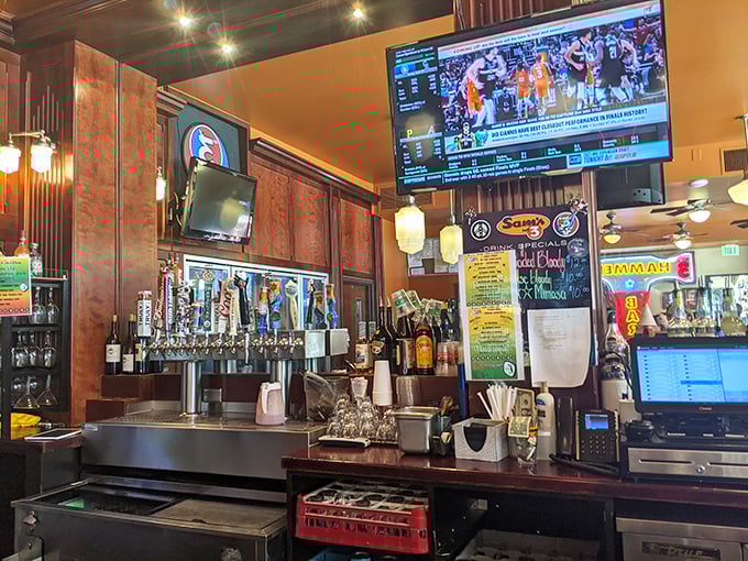The bar area proves Sam's isn't just for breakfast—it's an all-day affair where sports on TV meet spirits in glasses.
