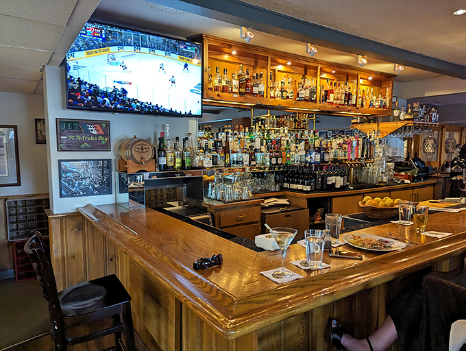The bar area strikes that perfect balance—enough bottles to make anything you fancy, yet cozy enough to feel like your neighborhood watering hole.