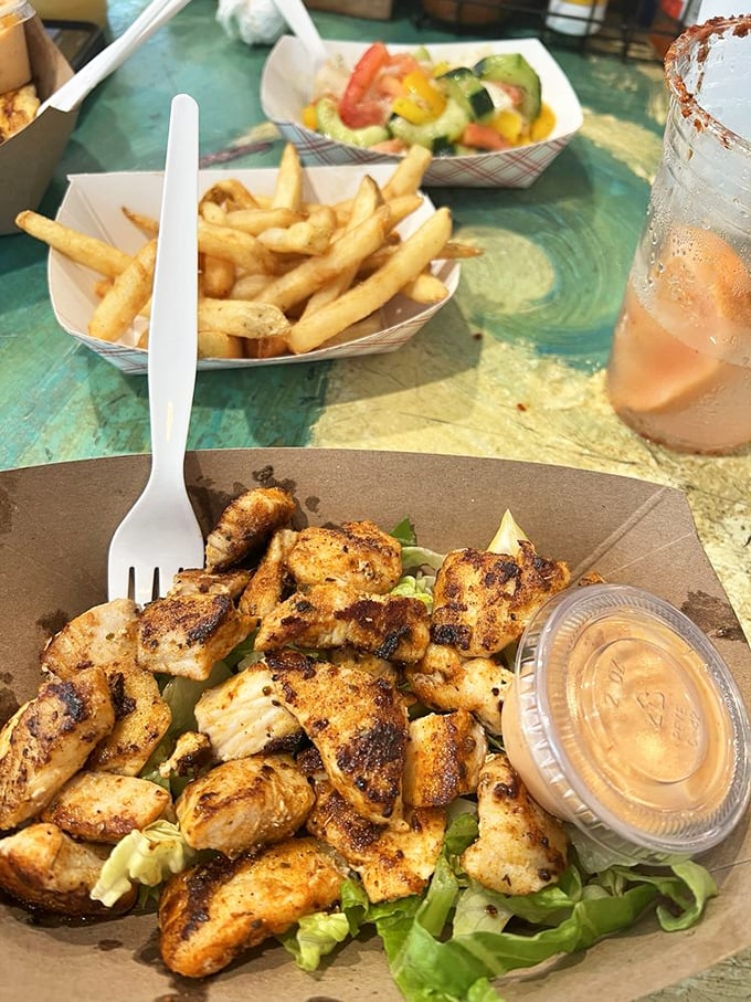 The ultimate beach comfort food: crispy bites smothered in creamy goodness with a side salad pretending you're being virtuous.