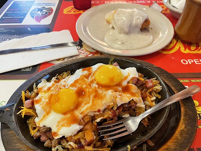 A breakfast skillet that's essentially a morning party in cast iron—eggs, hash browns, and breakfast meats mingling under a blanket of melted cheese.