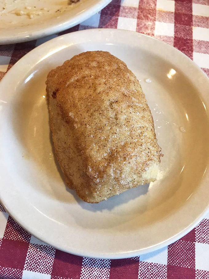 The cinnamon roll isn't dessert—it's a dining companion. Warm, sweet, and dusted with cinnamon-sugar that glistens like edible fairy dust.