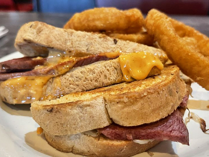 A sandwich that requires both hands and a strategy. The melted cheese is making a break for it, and who could blame it?