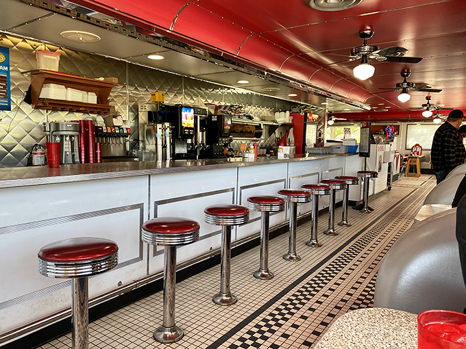 The heart of any great diner beats strongest at this welcoming counter overlooking kitchen magic. 