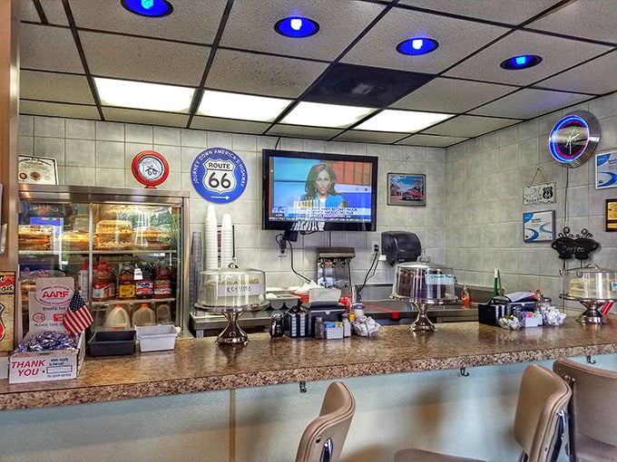 The counter where regulars become family and first-timers become regulars. Note the pie case standing guard like a dessert sentinel.
