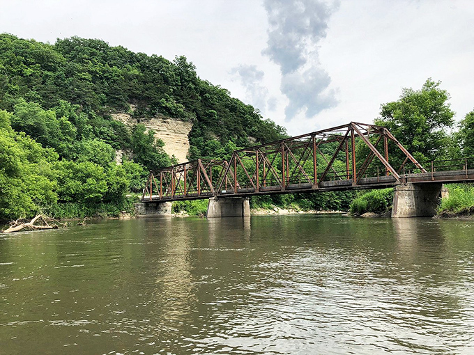 This isn't just any bridge—it's a portal between riverbanks that's been connecting Decorah's people and stories for generations.