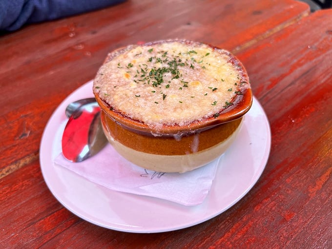 This isn't just soup—it's a commitment. Beneath that cheesy blanket lies an onion broth that's been simmering its way to perfection.