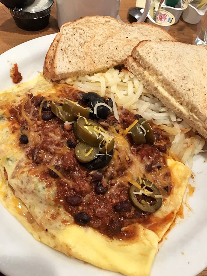 This isn't just an omelet—it's a Tex-Mex fiesta where eggs invited jalapeños, black beans, and cheese to party under a blanket of chili.
