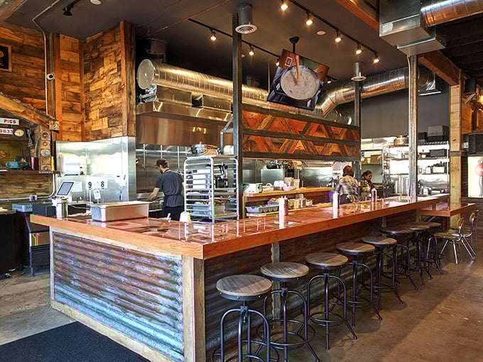 The open kitchen bar seating offers dinner and a show—watch the culinary choreography that transforms humble chicken into Portland legend.