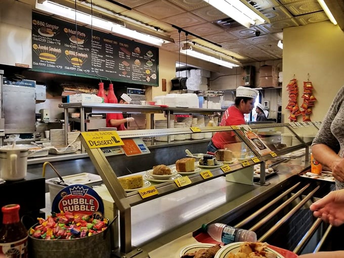The counter where magic happens – desserts tempting you despite your belt's protests. The staff knows you'll cave eventually.