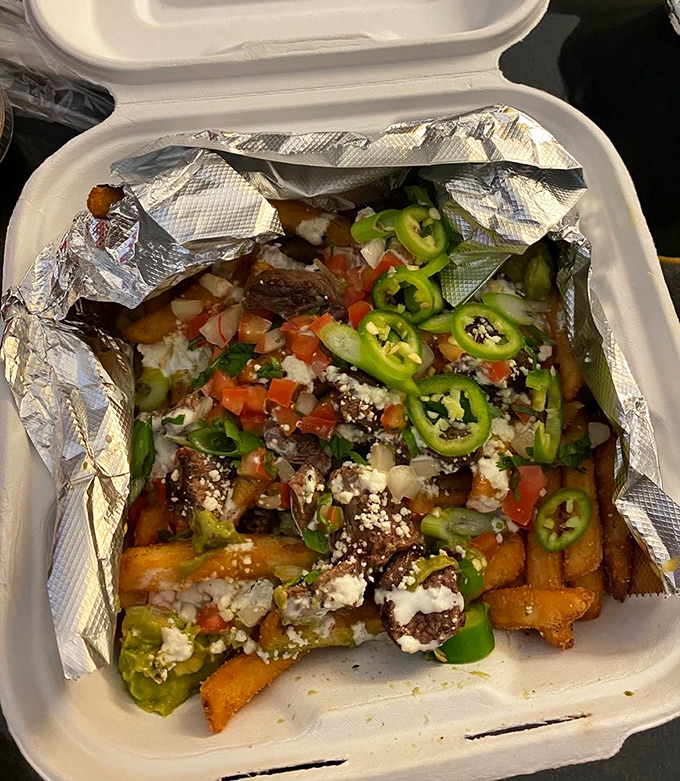 Asada fries—the culinary equivalent of a bear hug. Crispy potatoes playing host to a fiesta of toppings that would make any potato proud.