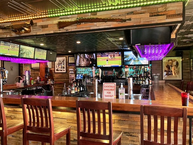 The bar area strikes that perfect balance between sports-watching haven and serious drinking establishment. Those purple lights aren't just ambiance—they're a mood.