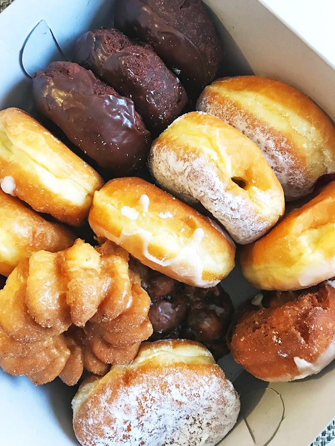 A box of joy containing every donut personality—from the flashy sprinkle-covered extrovert to the sophisticated chocolate-glazed intellectual.