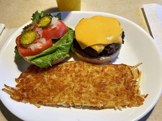 This isn't just a burger—it's breakfast's afternoon cousin stopping by for a visit. Those hash browns are the crispy golden welcome mat we all deserve.