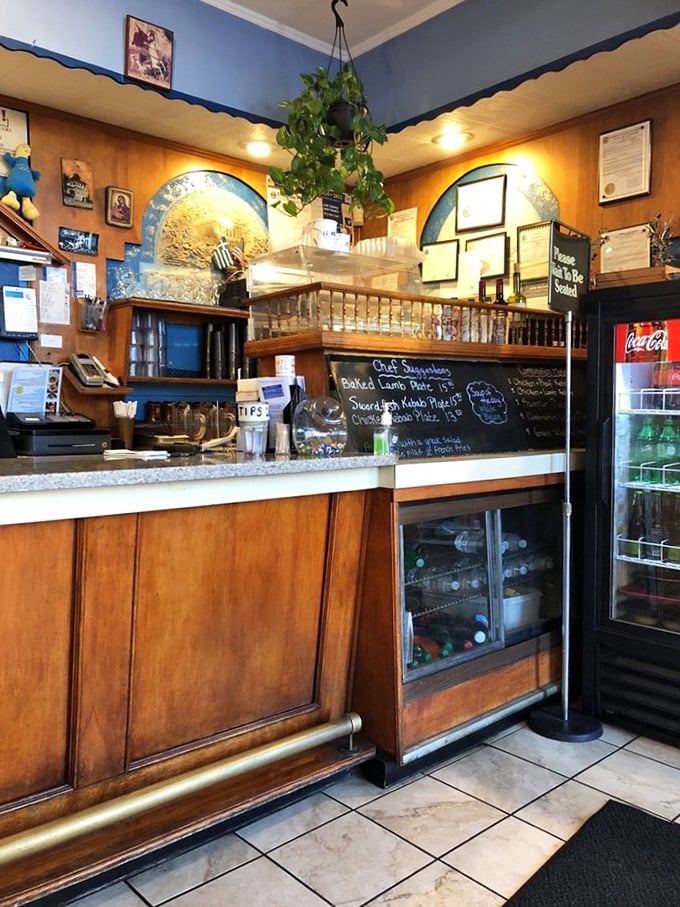 The counter where dreams come true. Behind that wooden façade lies the kitchen where Mediterranean magic happens daily.