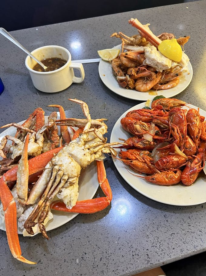 The seafood motherlode—crab legs splayed like trophies next to spicy crawfish and plump shrimp, a trio that transforms ordinary diners into maritime treasure hunters.