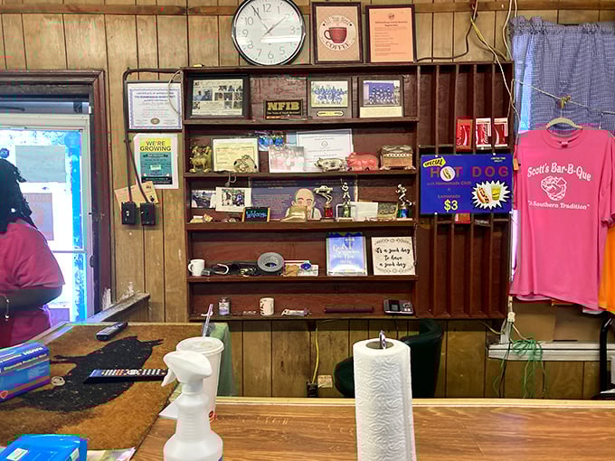 The wall of fame and merchandise corner—where barbecue legends are celebrated and t-shirts become souvenirs of your meat pilgrimage.