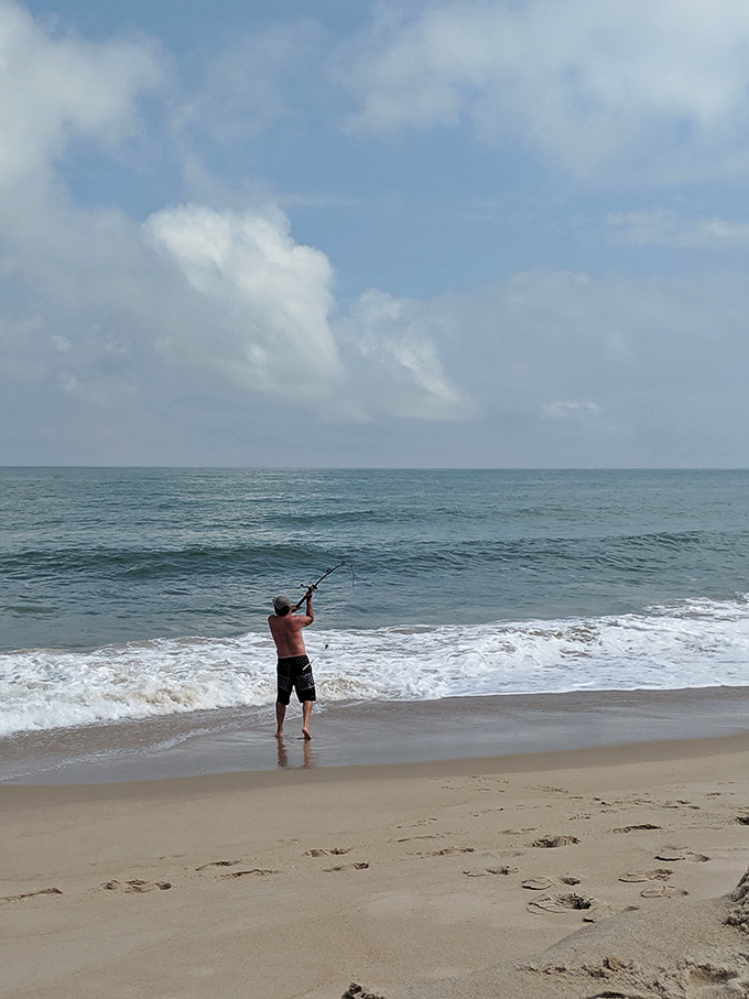 The timeless dance between angler and ocean. Some call it fishing; others call it standing in water holding a stick—both are right.