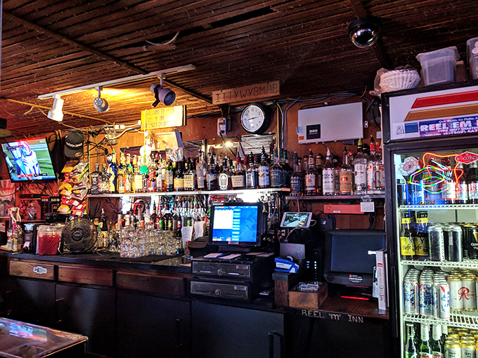 Behind the bar, bottles gleam like treasures. This isn't just a liquor selection—it's a carefully curated collection for washing down that legendary chicken.