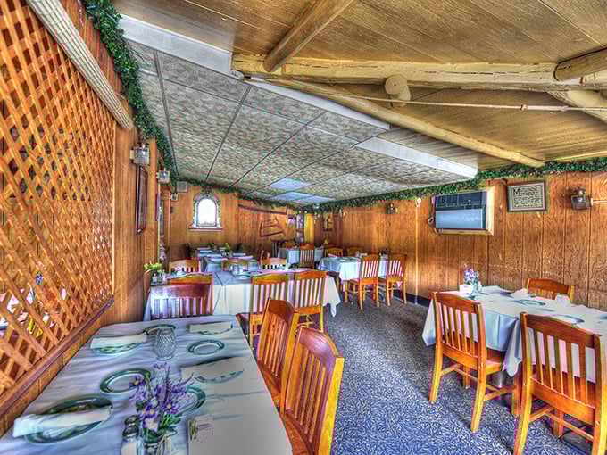 Sunlight streams through this dining space where white tablecloths meet wooden walls—the perfect setting for both special occasions and "just because it's Wednesday" meals.