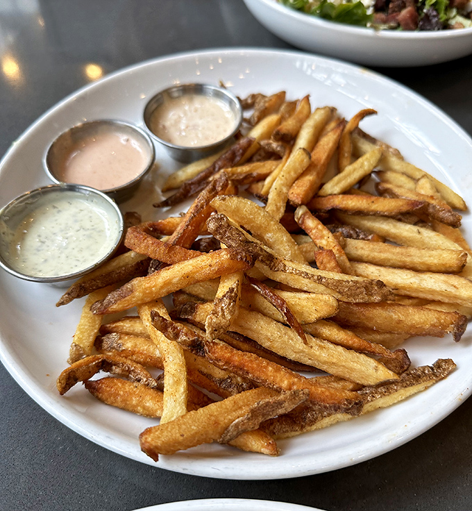 House-cut fries with three dipping sauces—because choosing just one would be like picking a favorite child. Crispy on the outside, fluffy within.