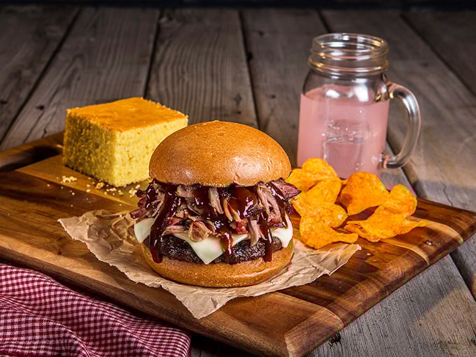 The pulled pork burger doesn't just blur the line between sandwich categories—it obliterates it. That cornbread square is the supporting actor who steals the show.