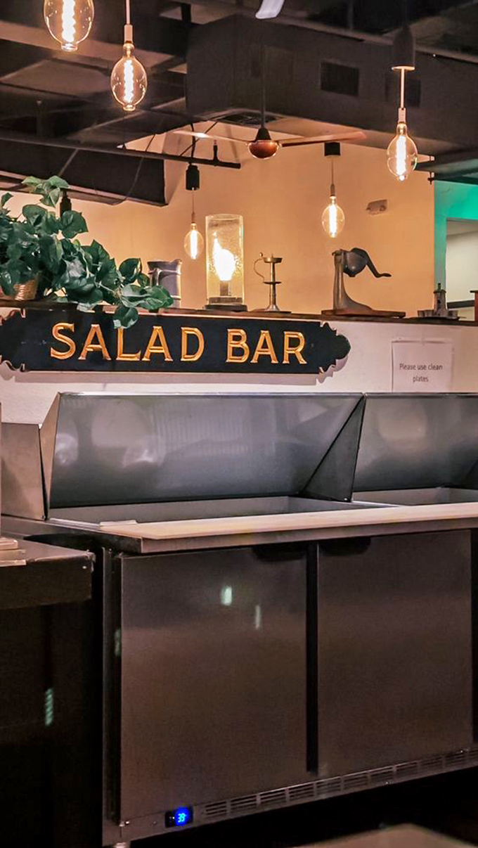The salad bar sign illuminated like Broadway marquee—because in the world of steakhouses, a good salad bar deserves its own spotlight.