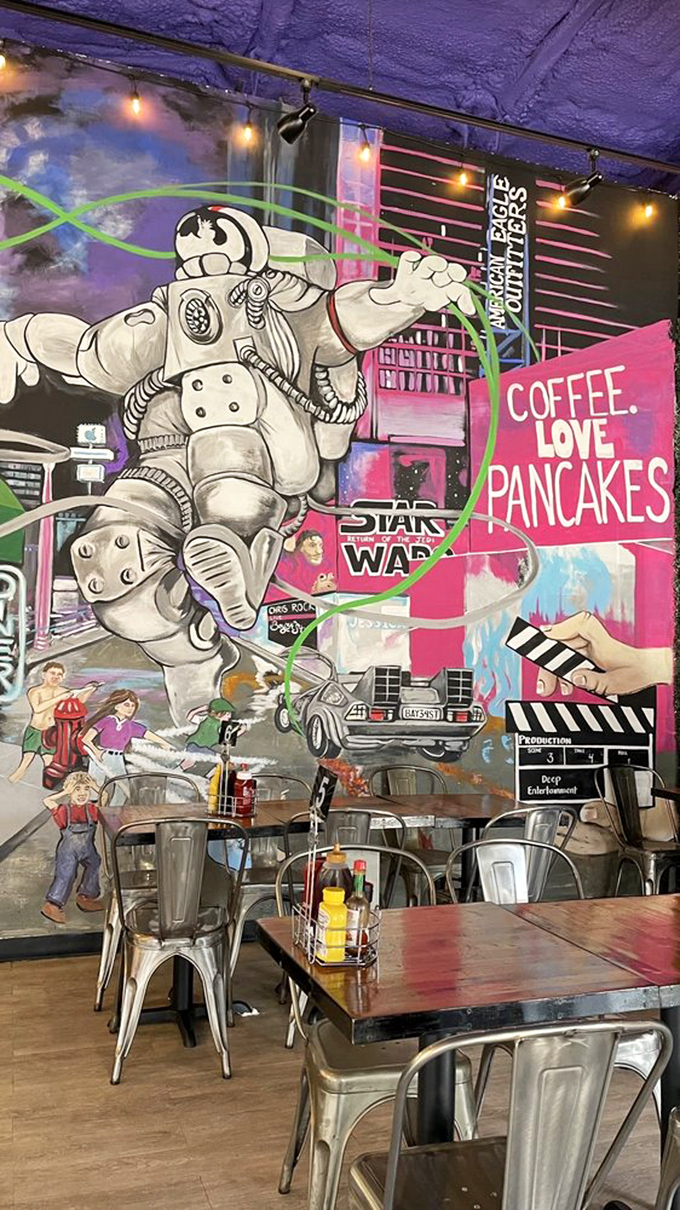 That mural featuring an astronaut declaring "COFFEE. LOVE. PANCAKES." is basically the breakfast version of "Live, Laugh, Love"—but infinitely cooler.