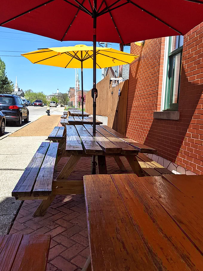 Al fresco dining under bright yellow umbrellas - because sauce-stained shirts are easier to explain when you're sitting outside.