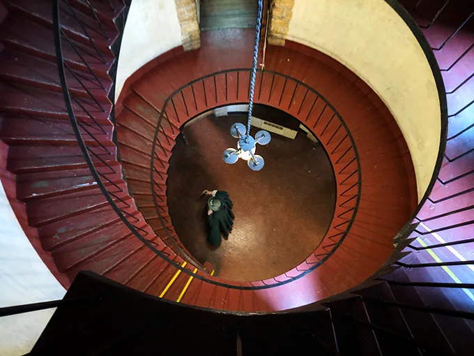 The spiral staircase winds dramatically downward, practically begging you to make a grand entrance while humming "Game of Thrones" theme music.