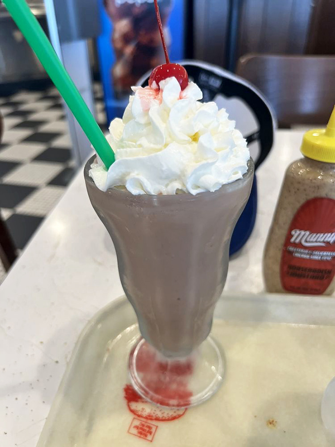 A proper deli milkshake topped with whipped cream and a cherry—because sometimes adults deserve to eat like the children they still are inside.