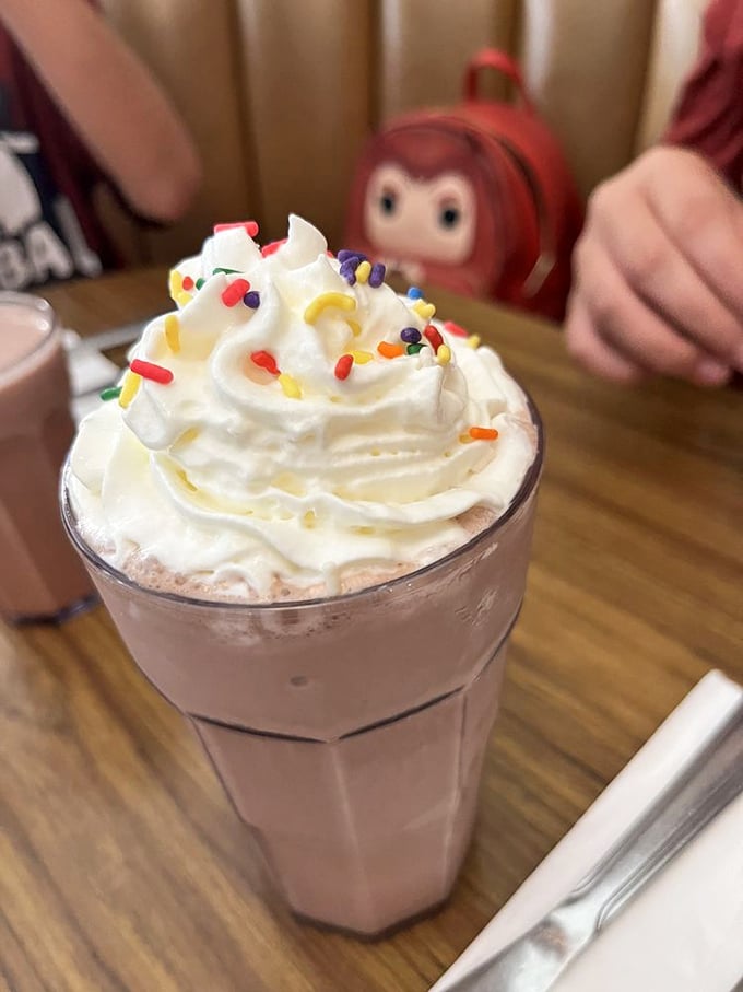 This isn't just a milkshake—it's a dessert skyscraper with whipped cream penthouse and sprinkle rooftop garden.