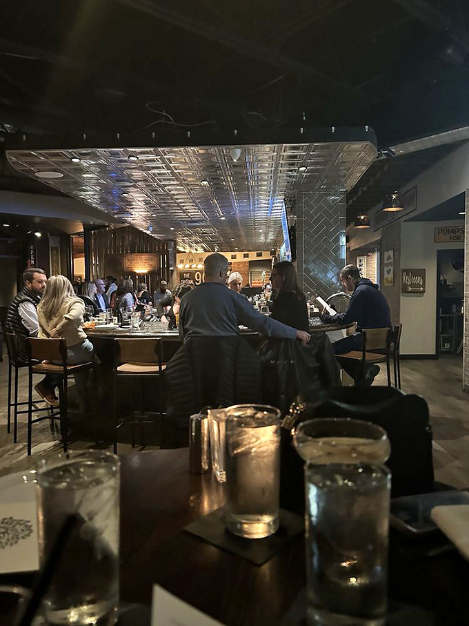 The bustling bar area where strangers become friends, united by the universal language of excellent food and flowing spirits.