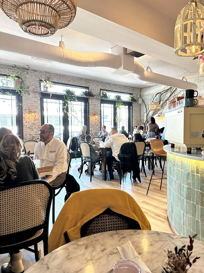 Bustling with diners beneath wicker light fixtures—this is where breakfast dreams and morning conversations intersect in delicious harmony.