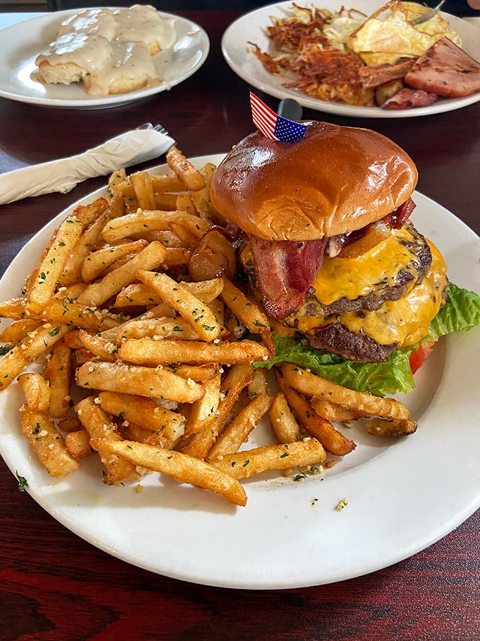 Behold the burger of your dreams—juicy patty, melted cheese, crispy bacon, and golden fries that deserve their own fan club.